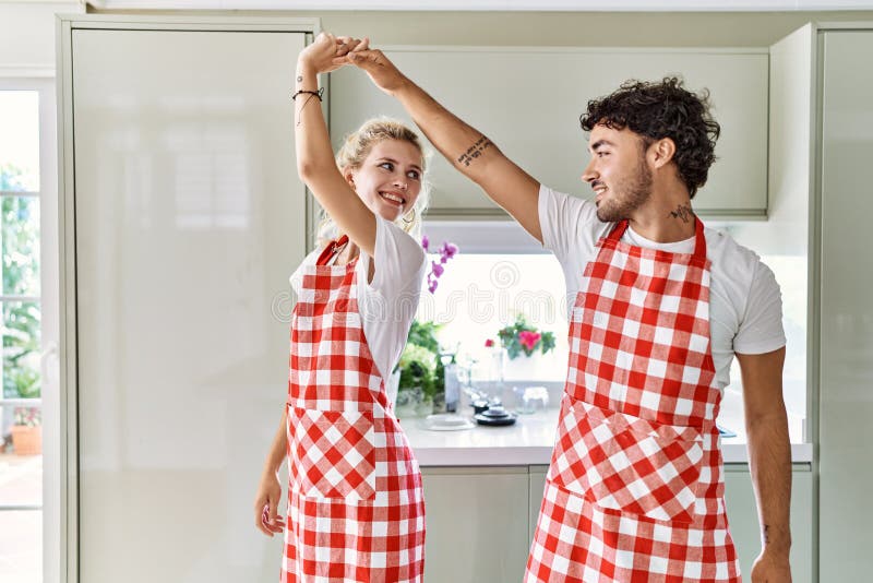 Young Couple Smiling Happy Cooking and Dancing at Kitchen Stock Image ...