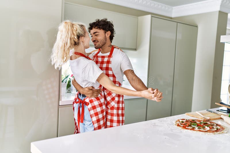 Young Couple Smiling Happy Cooking and Dancing at Kitchen Stock Image ...