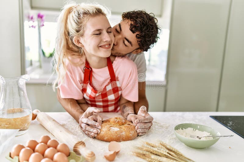 Young Couple Smiling Happy Cooking Homemade Bread at Kitchen Stock ...