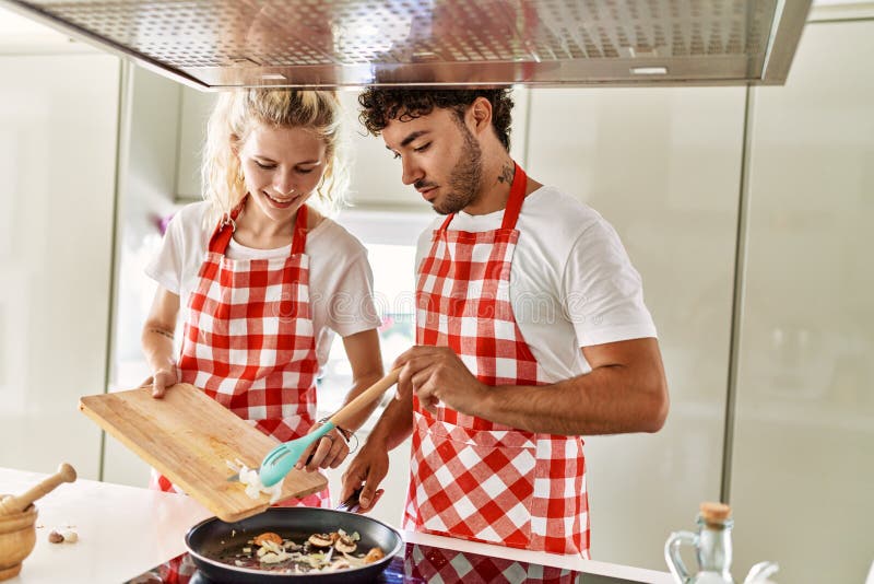 Young Couple Smiling Happy Cooking Using Frying Pan at Kitchen Stock ...