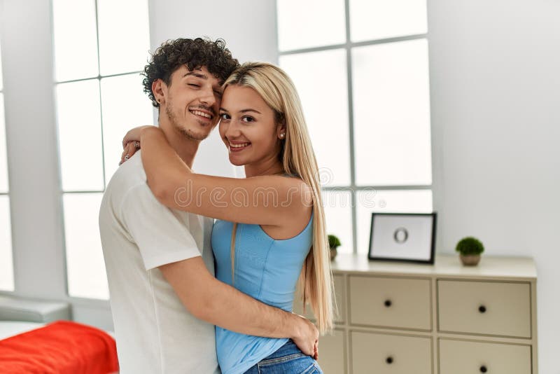 Young Couple Smiling Happy Hugging at Home Stock Photo - Image of ...