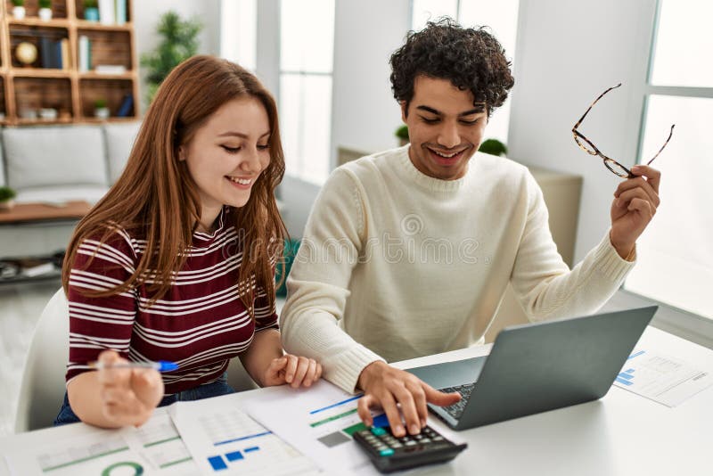 Young Couple Smiling Happy Using Laptop Sitting on the Table at Home ...
