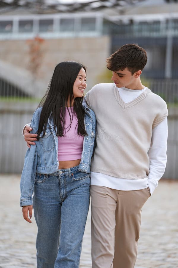 Young Couple Smiling while Walking Together Outdoors. Stock Image ...