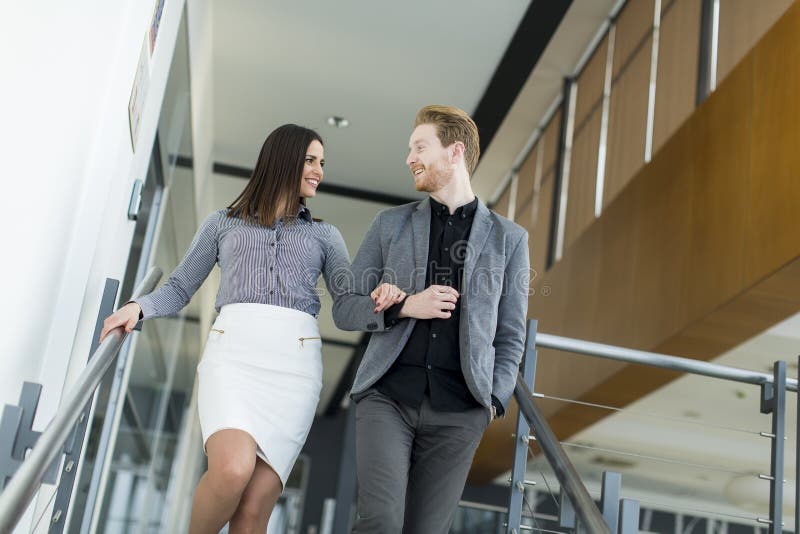 Young Couple on the Stairs in Office Stock Image - Image of stairway ...