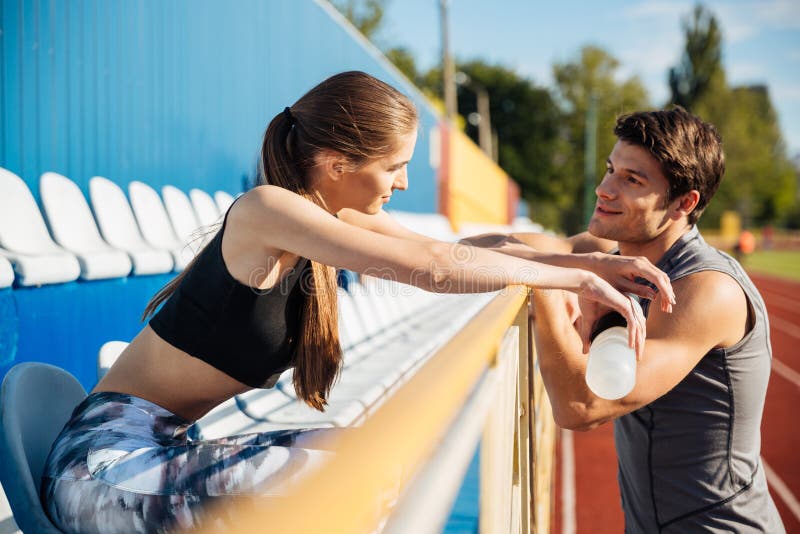 Young Couple Standing and Talking on Athletics Track Field Stock Image ...