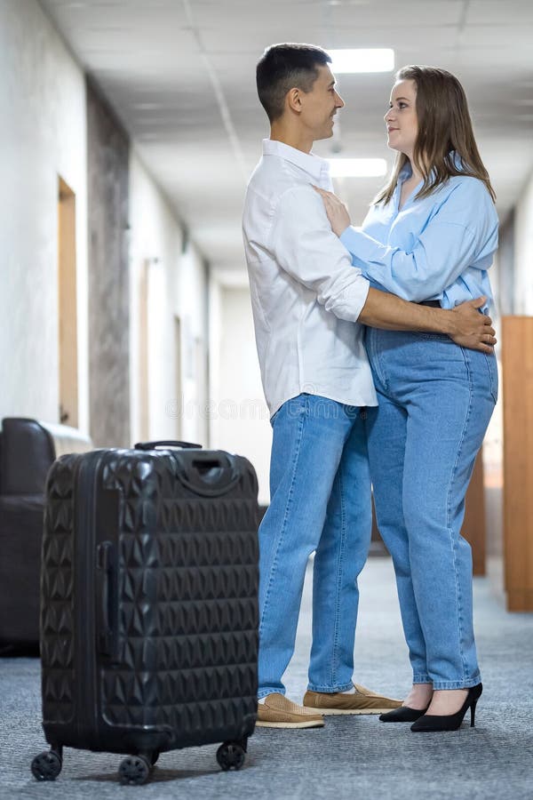 Young Couple Stands Hugging in Illuminated Hotel Hallway Stock Image ...