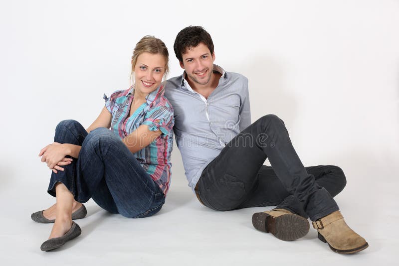 Young Couple of Students Sitting Down Isolated Stock Image - Image of ...