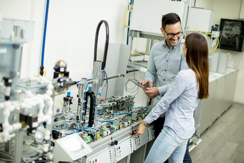 Young Couple of Students Working at Robotics Lab Stock Image - Image of ...