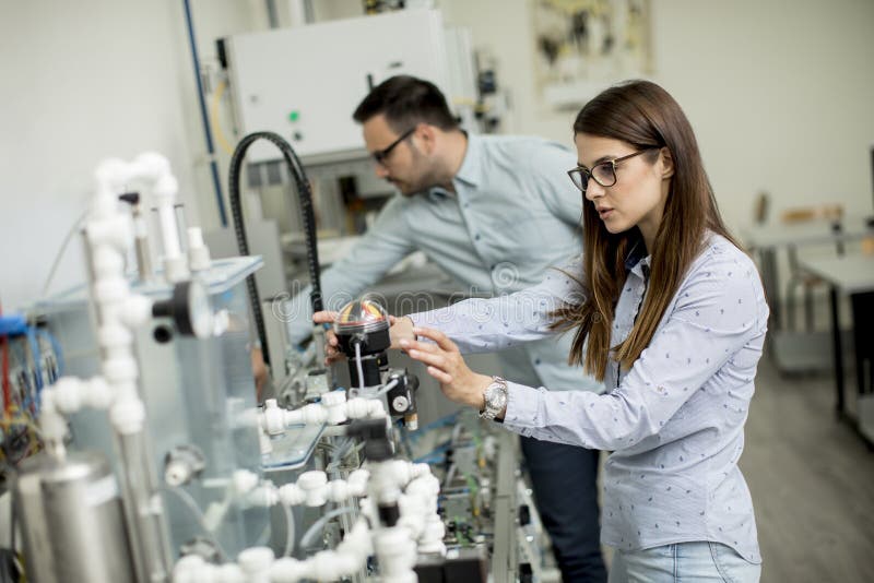Young Couple of Students Working at Robotics Lab Stock Photo - Image of ...