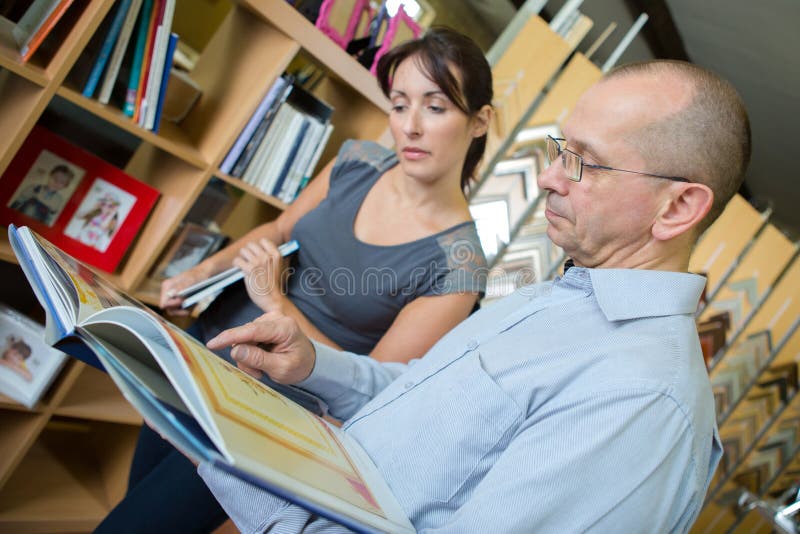 Young Couple Study Brochure Together Stock Photo - Image of happy, away ...