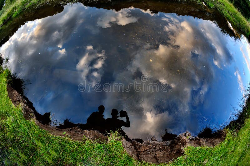 Young Couple Taking Photo of Their Reflection in the Water Stock Photo ...
