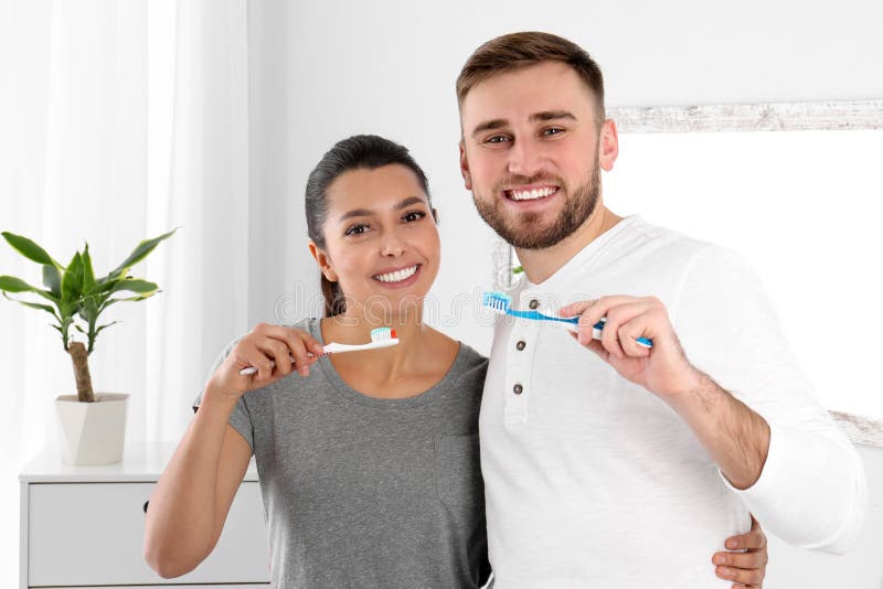 Young Couple with Toothbrushes in Bathroom Stock Image - Image of home ...