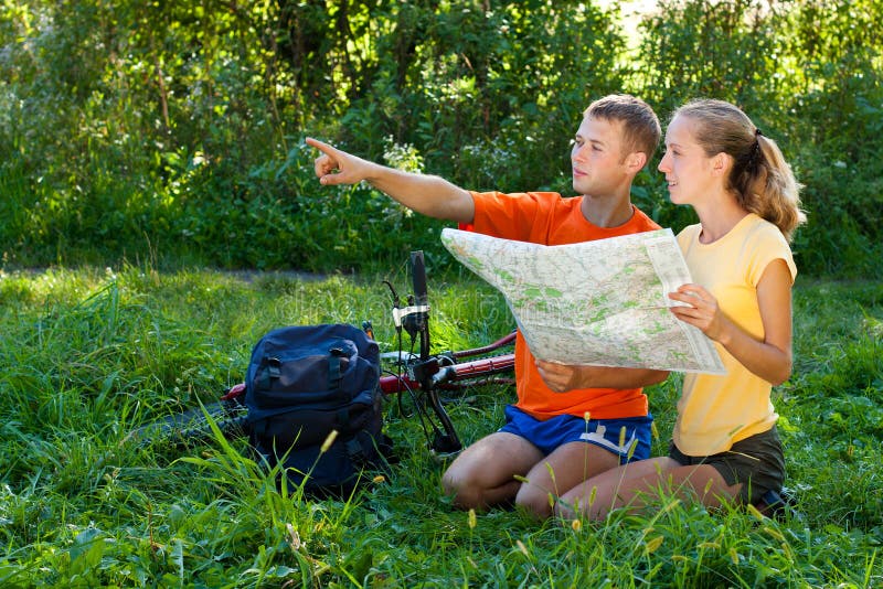 Two hikers with the map stock image. Image of hand, lost - 5391043