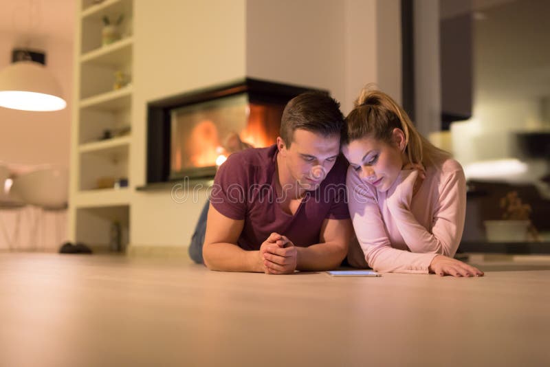 Young Couple Using Digital Tablet on Cold Winter Night Stock Photo ...