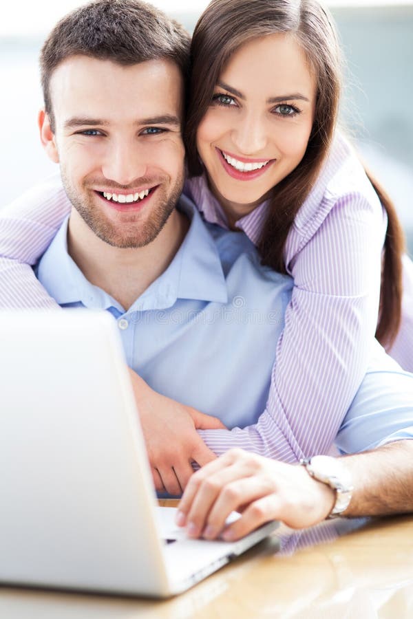 Young couple using laptop stock image. Image of hugging - 30764961