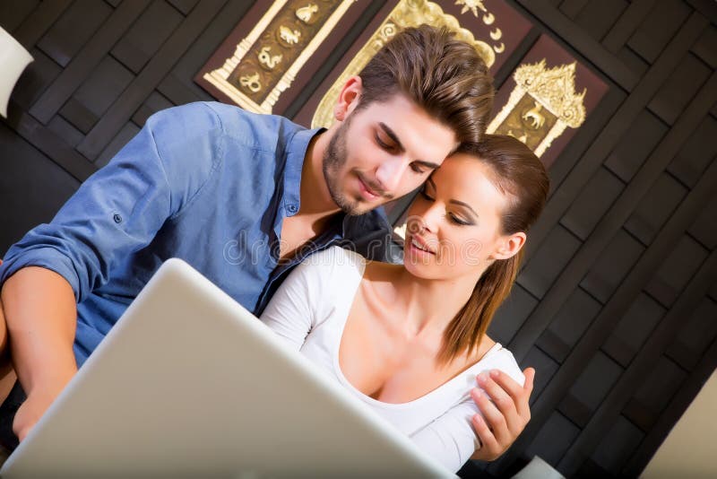 Young Couple Using a Laptop Computer in a Asian Hotel Room Stock Image ...