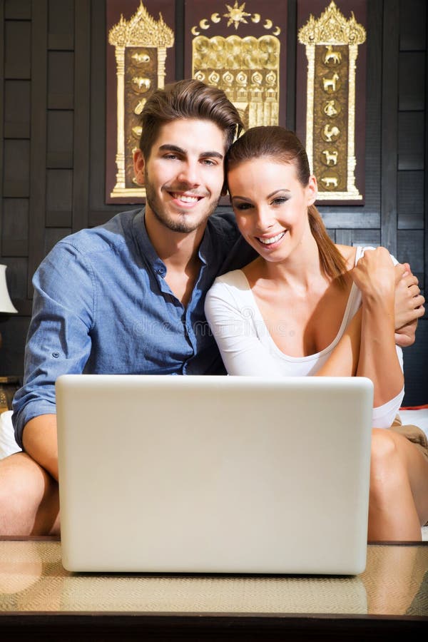 Young Couple Using a Laptop Computer in a Asian Hotel Room Stock Photo ...