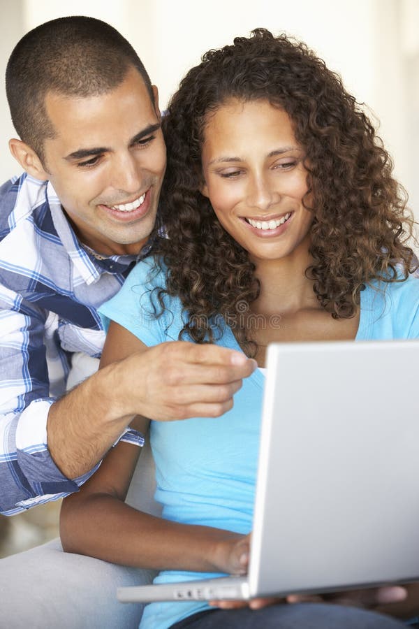 Young Couple Using Laptop Computer at Home Stock Photo - Image of ...