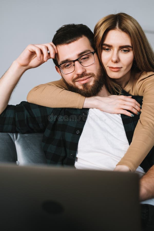 Young Couple Using Laptop Computer and Resting on the Sofa at Home ...