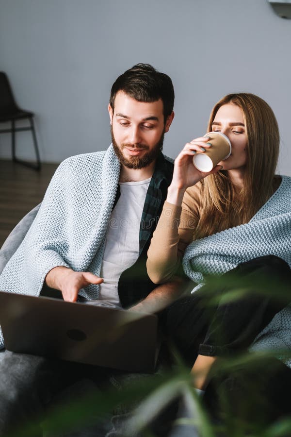 Young Couple Using Laptop Computer and Resting on the Sofa at Home ...