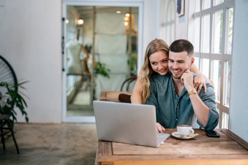 Young Couple Using Laptop on Desk at Home and Think. the Concept of Couples Sharing One Idea ...