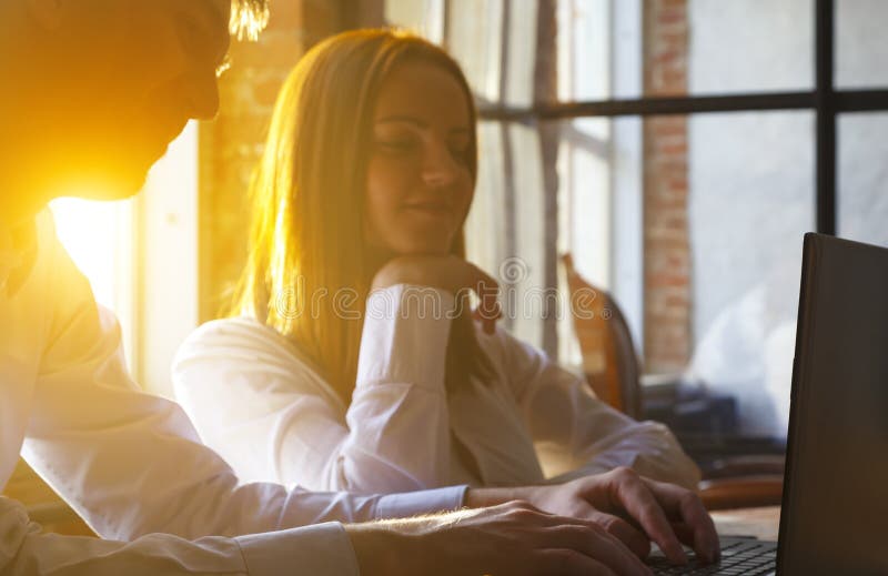 Young Couple Using Laptop on Desk at in a Modern Office, Loft Style and ...