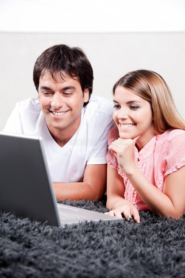 Young Couple Using Laptop stock image. Image of leisure - 36978631