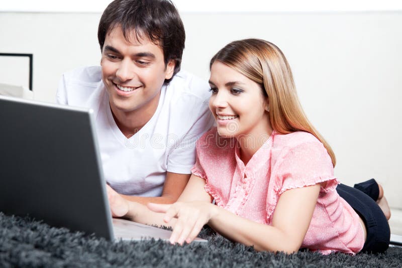 Young Couple Using Laptop stock photo. Image of attractive - 36825364