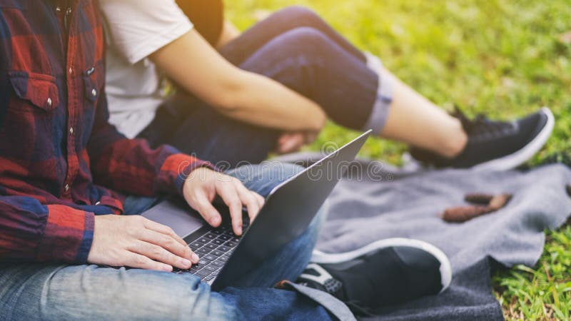 A Young Couple Using and Looking at Laptop Computer Together Stock ...