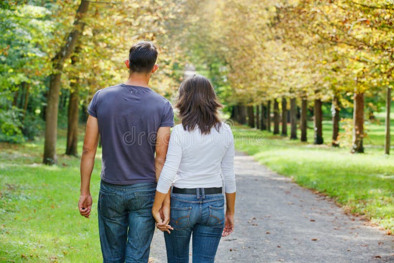 Young Couple Walking in Autumn Park Stock Image - Image of clothing ...