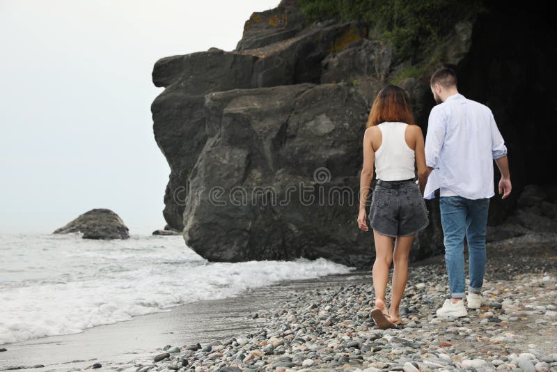 Young Couple Walking on Beach Near Sea, Back View. Space for Text Stock ...