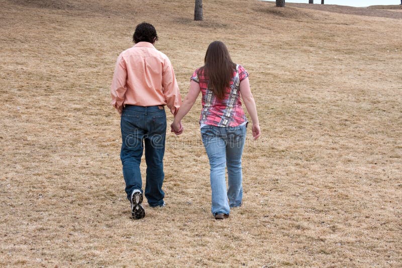 Young Couple Walking Hand in Hand Stock Image - Image of romantic ...