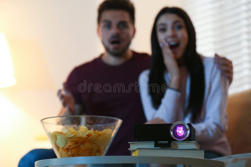 Young Couple Watching Movie, Focus on Video Projector Stock Image ...