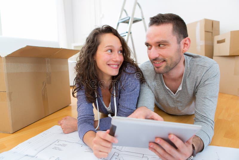 Young Couple Watching Plans in Their New Flat Stock Photo - Image of ...