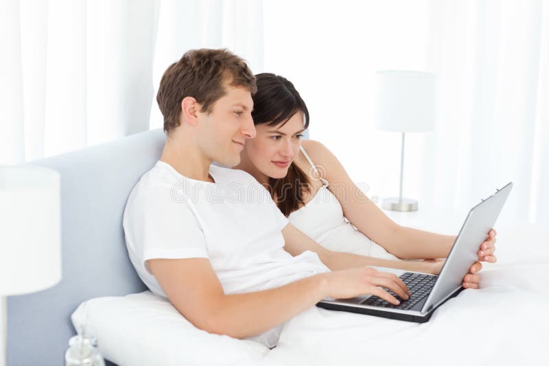 Young Couple Watching Videos on Their Computer Stock Photo - Image of ...