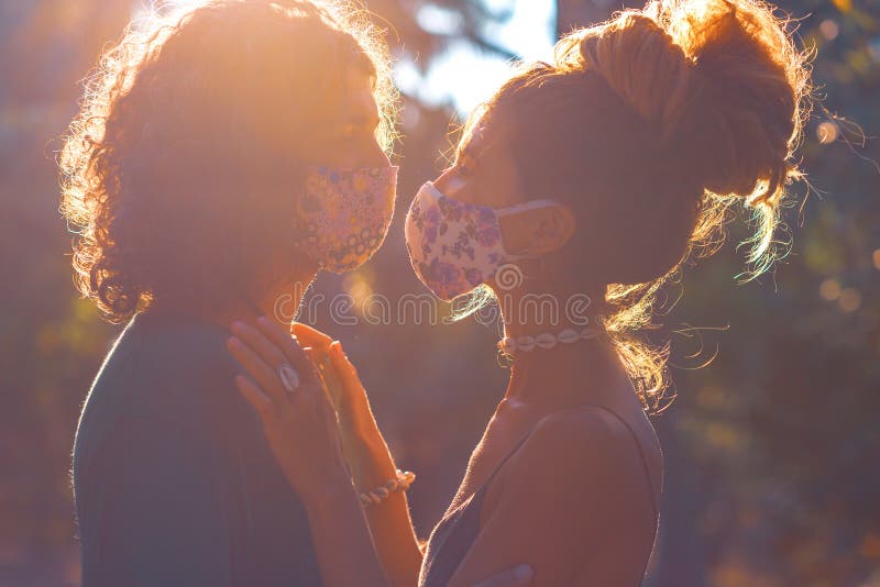 Young Couple Wearing Face Mask Outdoors at Sunset Stock Photo - Image ...