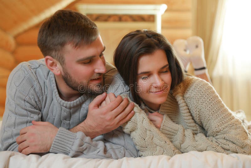 Young Couple Wearing Warm Sweaters on Bed Stock Image - Image of ...