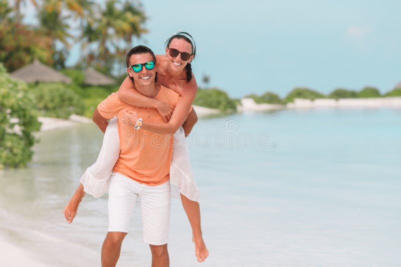 Young Couple On White Beach During Summer Vacation Happy Lovers Enjoy Their Honeymoon Stock