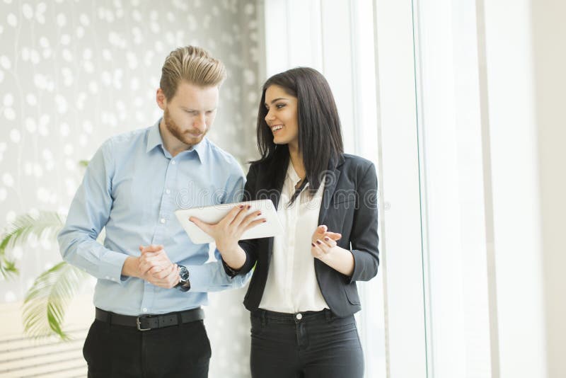 Young Couple Working in Office Stock Photo - Image of togetherness ...