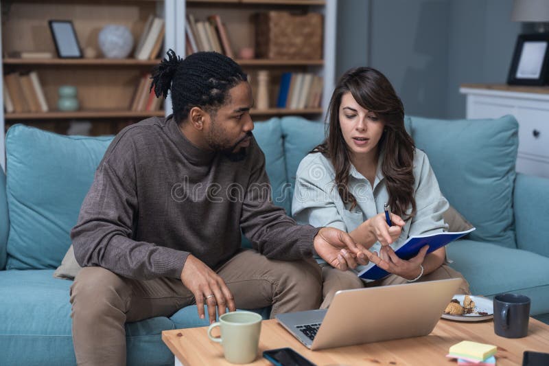 Young Couple Working Remotely at Home, Analyzing Documents and Data ...