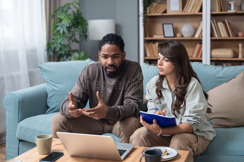 Young Couple Working Remotely at Home, Analyzing Documents and Data ...