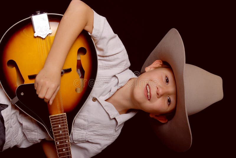 Young Cowboy Musician stock image. Image of play, isolated - 6591505