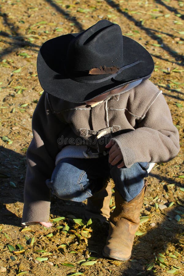 Cowboy Sitting On The Ground Stock Image - Image of cowboy, serious ...