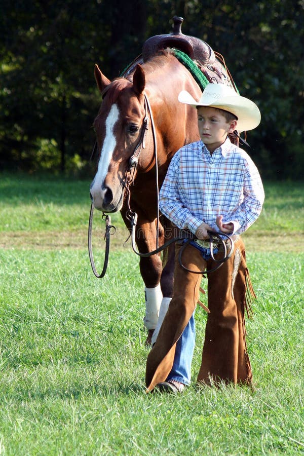 Young cowboy walking horse stock image. Image of creature - 6740357