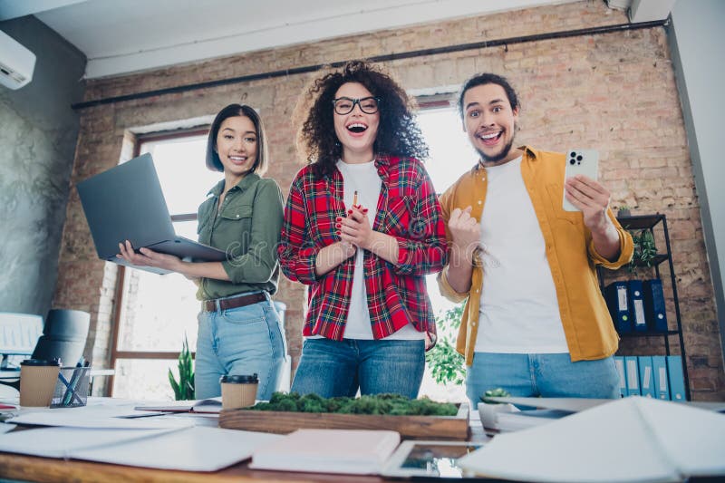 Young Coworkers Celebrating Success in a Collaborative Modern Office ...