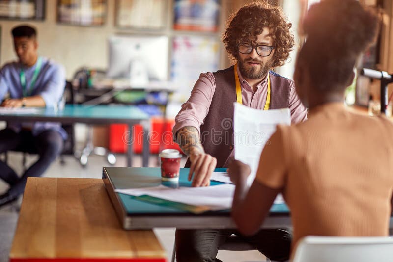 Young Coworkers Doing Reports Together Stock Photo - Image of meeting ...