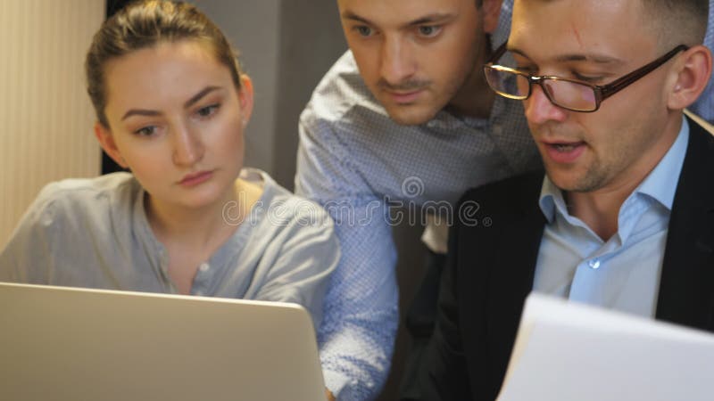 Young Coworkers Examining Statistical Data Information on Laptop at ...
