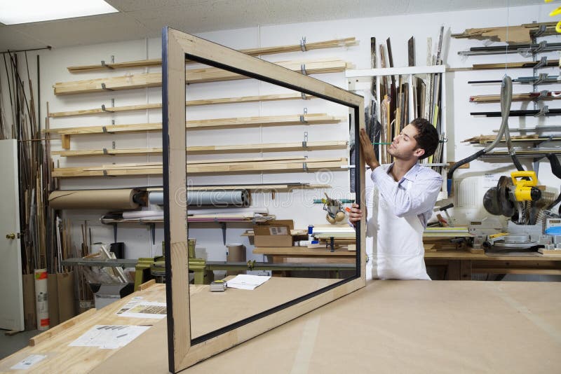Young Craftsman Concentrating on Making Picture Frame in Workshop Stock ...
