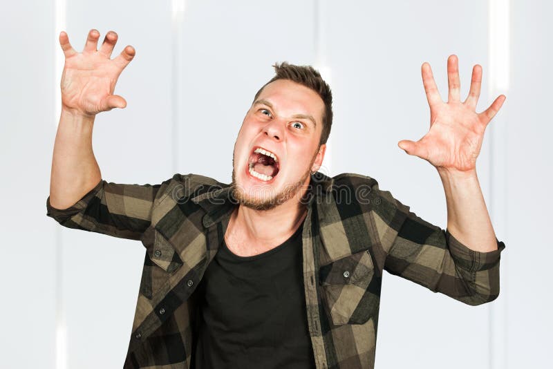 Young Crazy Guy Scares Like a Devil with Hands Up Stock Photo - Image ...