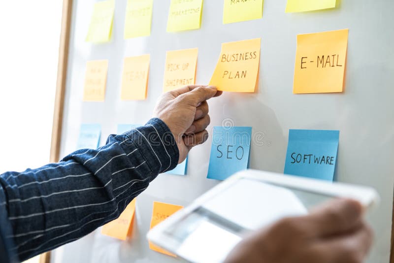 Young Creative Business People Use Post it Notes Sticky Note on Board ...